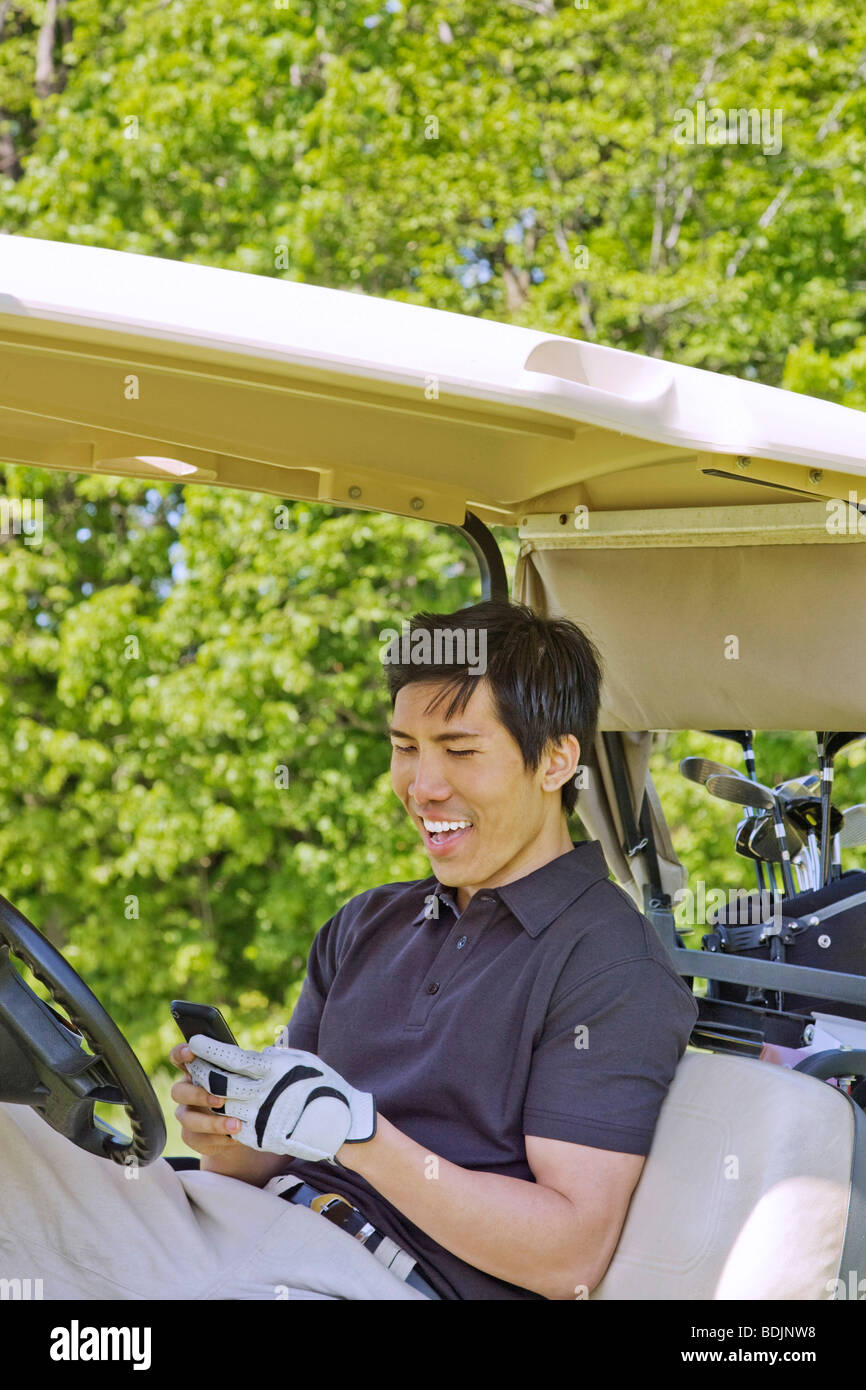 Man sitting in golf cart hi-res stock photography and images - Alamy