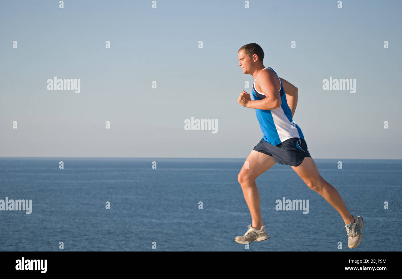 Man running by the sea Stock Photo - Alamy