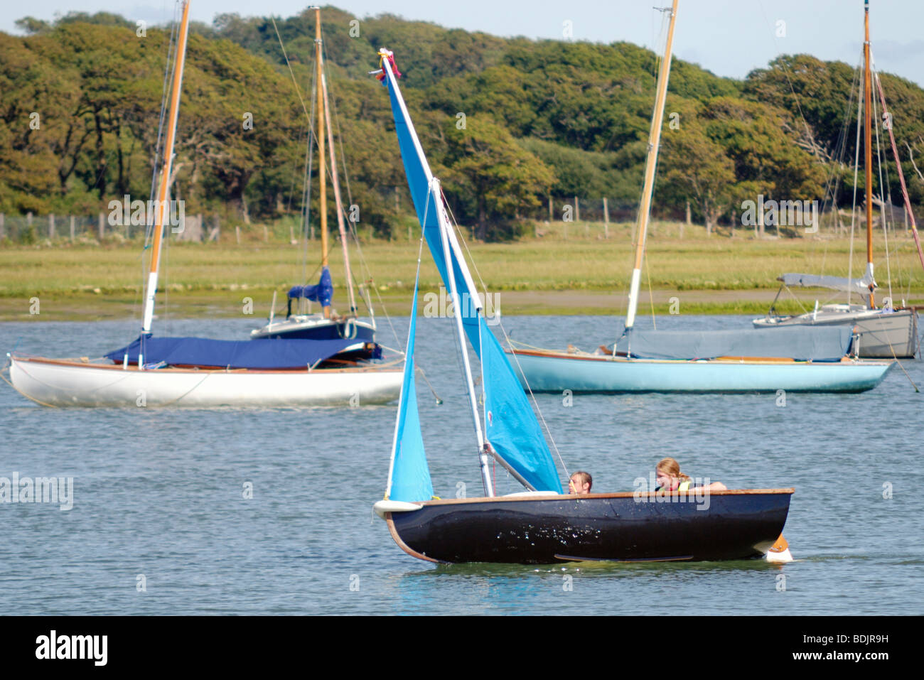 Two children sailing in a dingy Stock Photo - Alamy