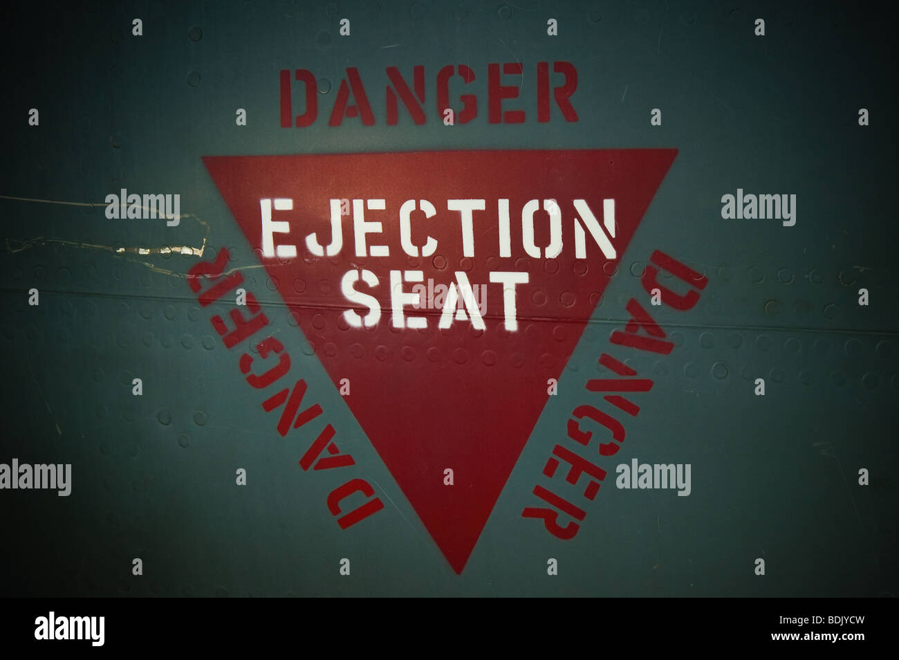 Closeup of Warning Ejection Seat Sign on side of aircraft fuselage ...