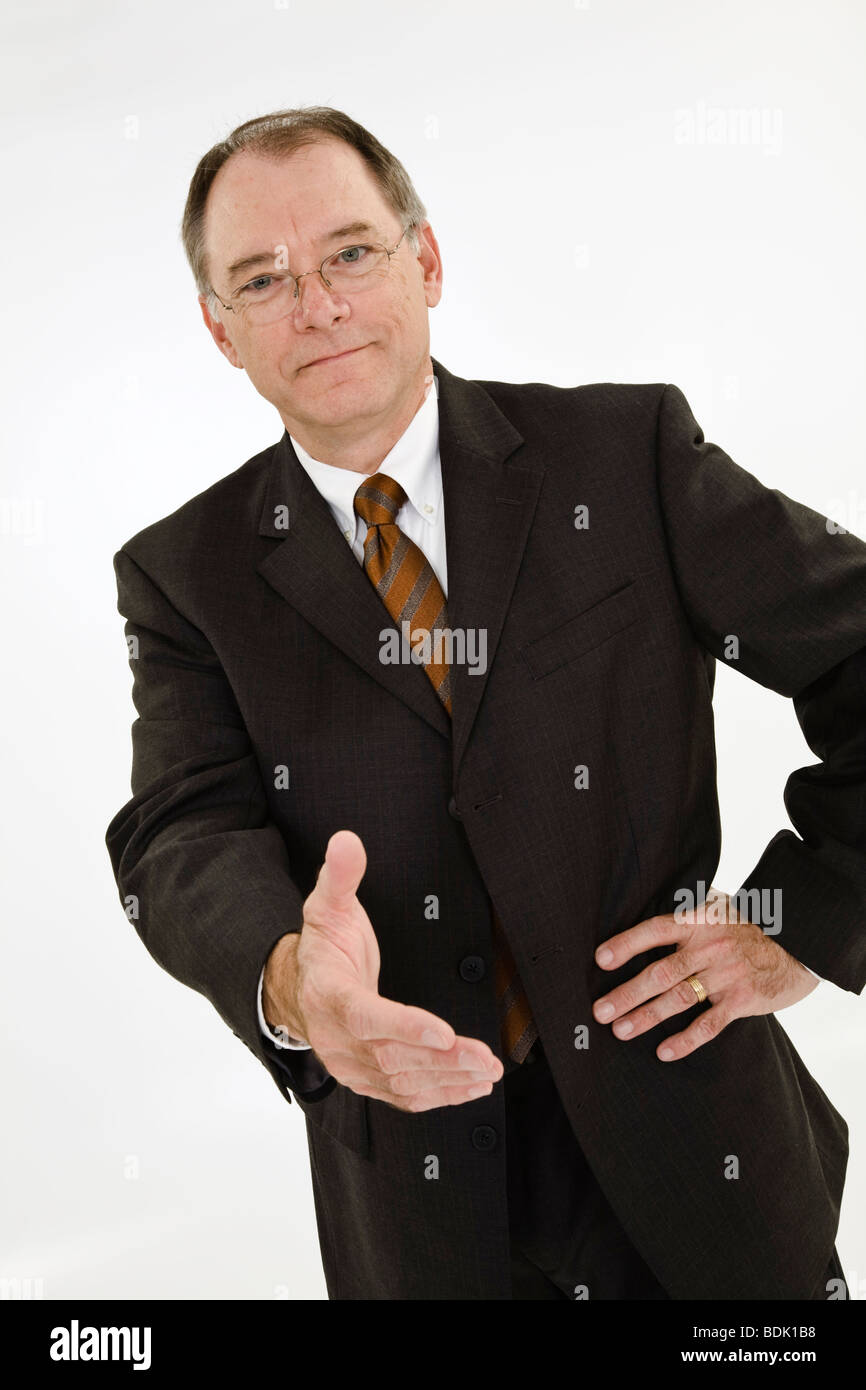 A caucasian businessman with a receding hairline wearing a black ...
