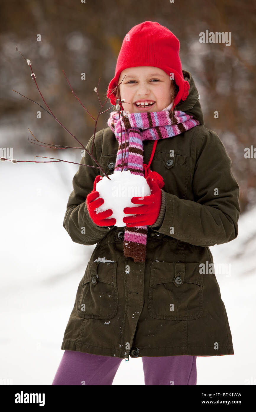 Little girl making snowballs Stock Photo - Alamy