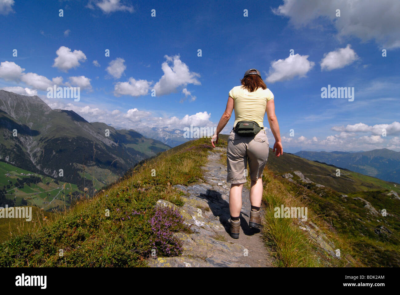 Female wanderer on the Glaser Grat in the swiss alps canton Graubuenden ...