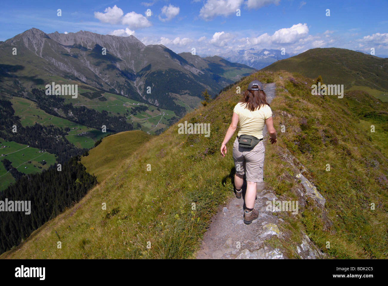 Female wanderer on the Glaser Grat in the swiss alps canton Graubuenden ...
