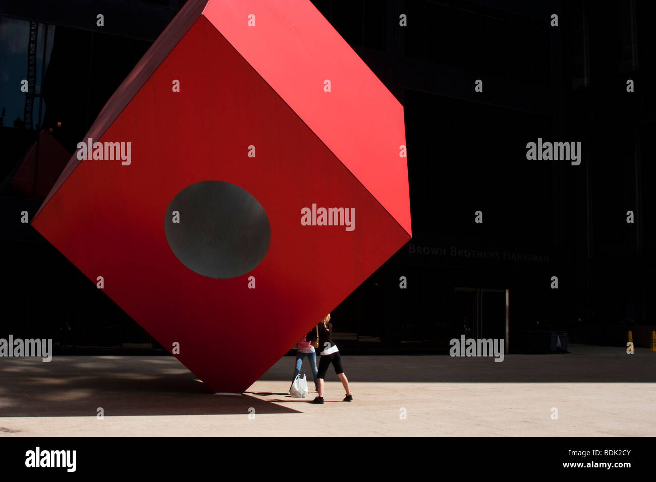 People pretend to support large scale public art sculpture Red Cube ...