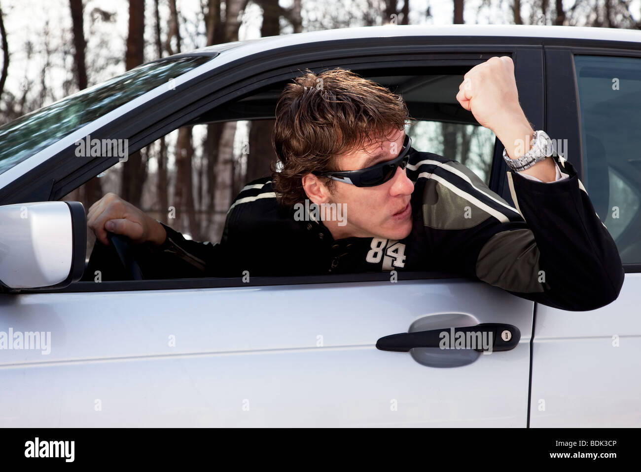 Aggressive driver driving a car and swearing Stock Photo - Alamy