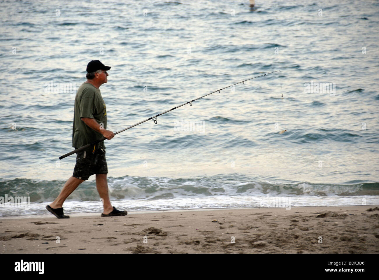 Florida beach scene, man with fishing pole Stock Photo - Alamy