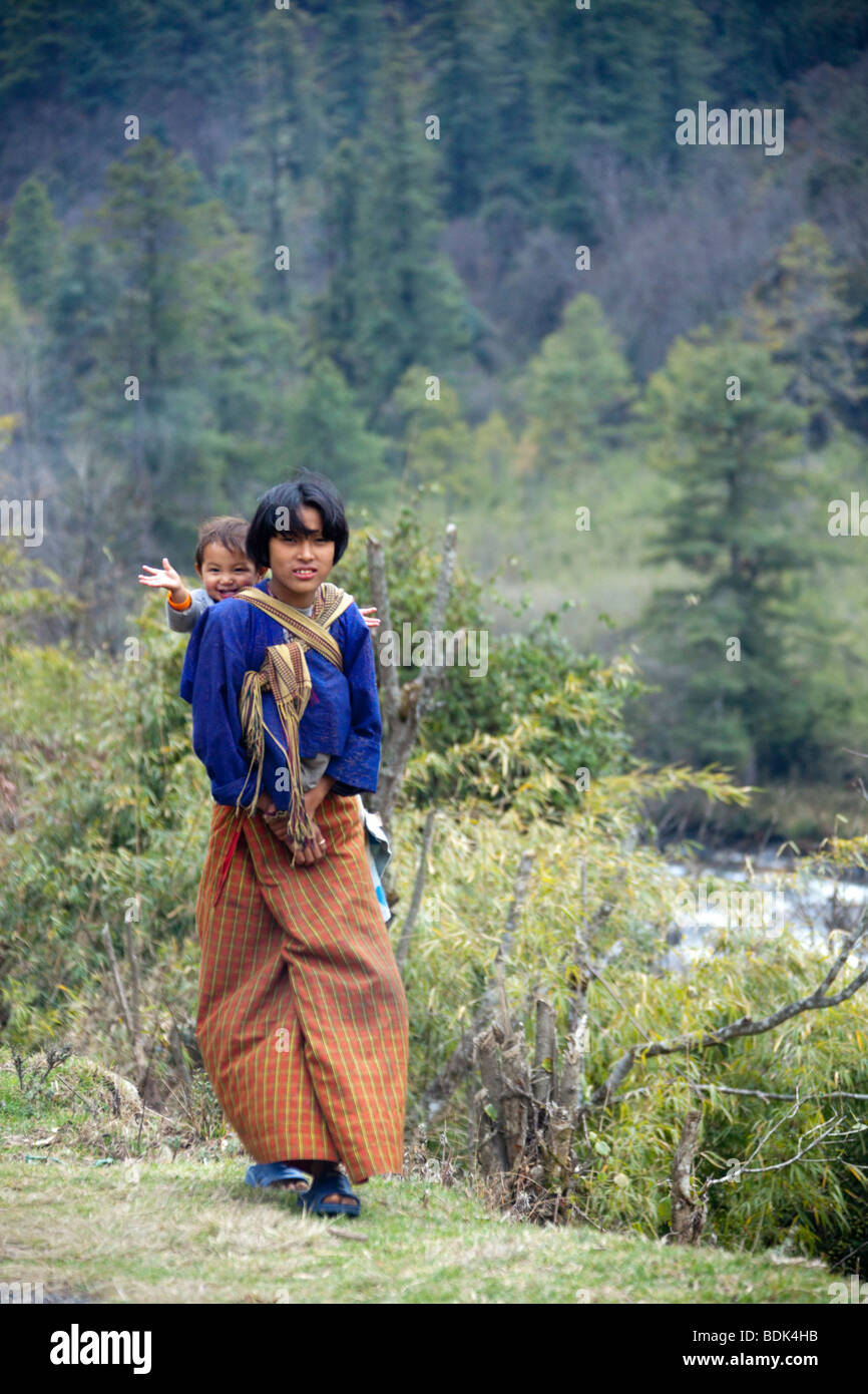 woman farm worker carrying baby on back. Bhutan Asia. 92064 Bhutan ...