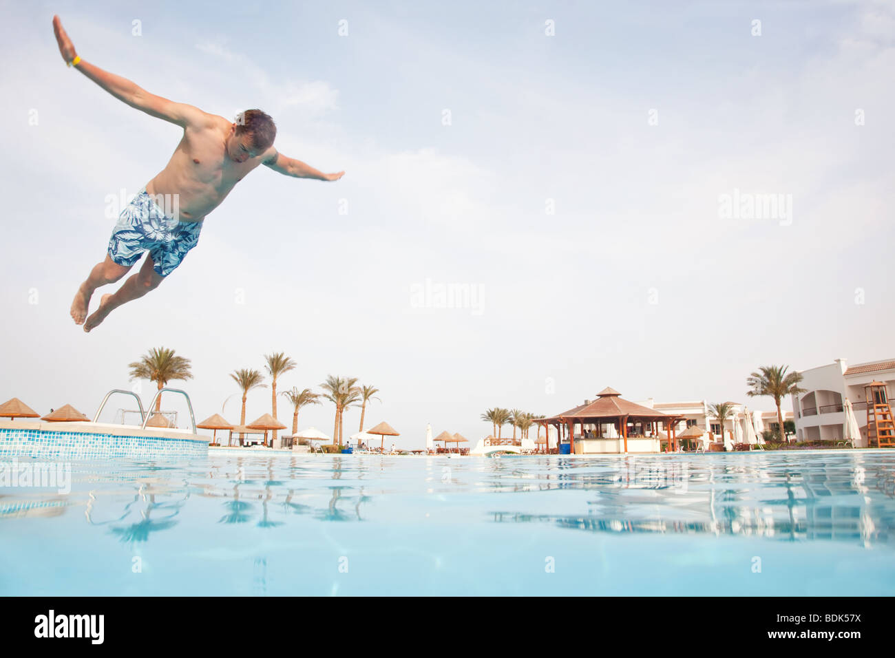 Cool man jumping in pool hi-res stock photography and images - Alamy