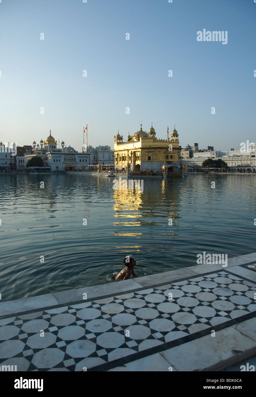 a child baths in the pool within the grounds of the golden temple ...