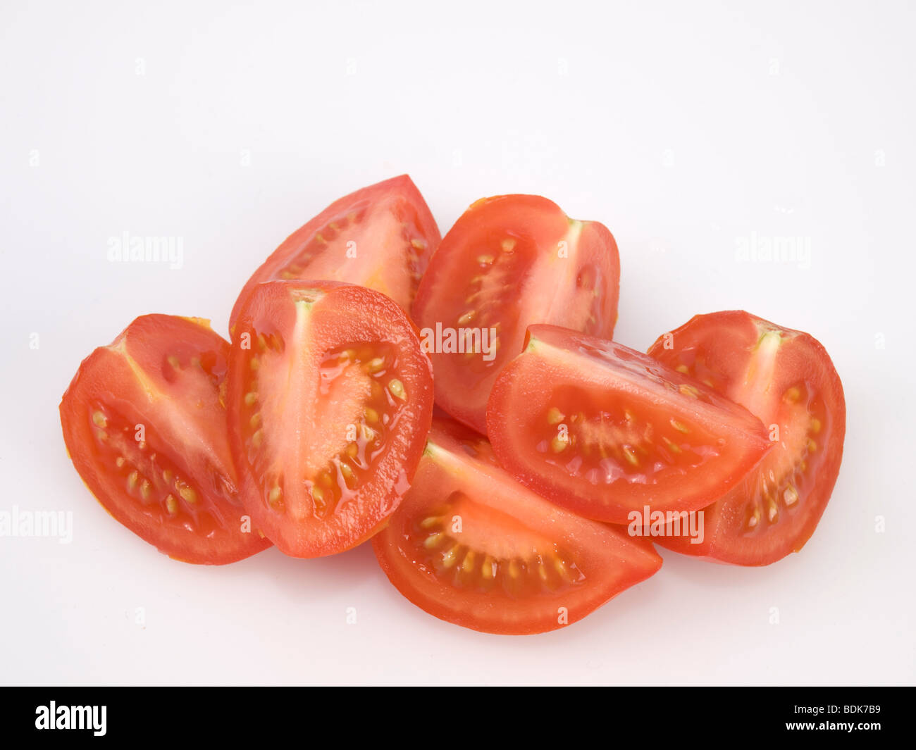 sliced red tomatoes on white back Stock Photo - Alamy