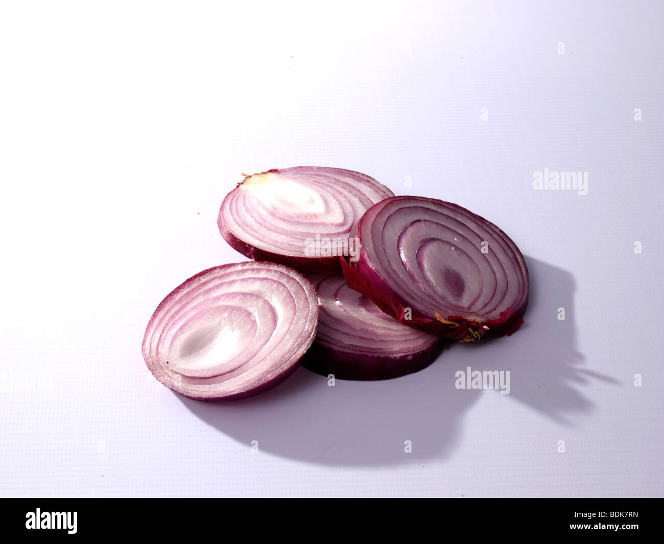sliced red onion on a white tabletop Stock Photo - Alamy