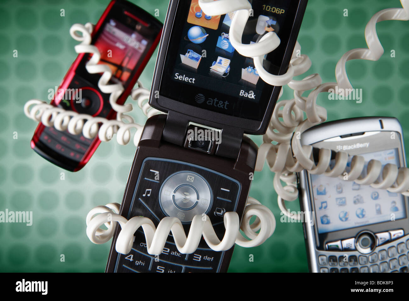 Cell phones floating on green background, wrapped with old fashioned ... Cell phones floating on green background, wrapped with old fashioned ...