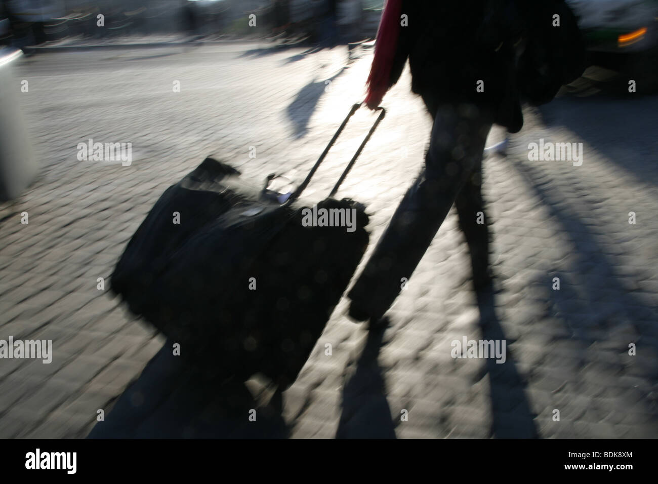 young man pulling trolley luggage case in town Stock Photo - Alamy