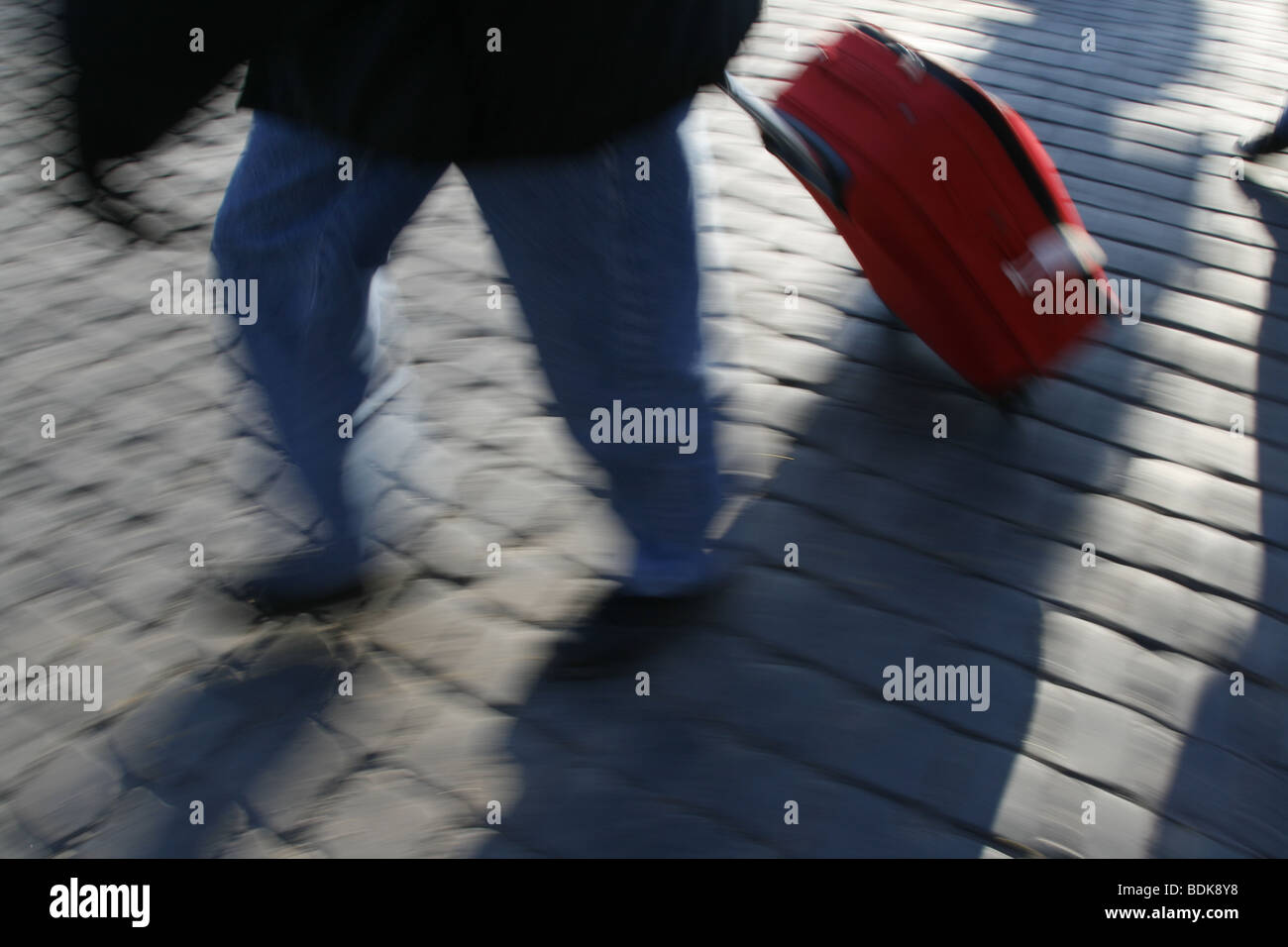 young man pulling trolley luggage case in town Stock Photo - Alamy