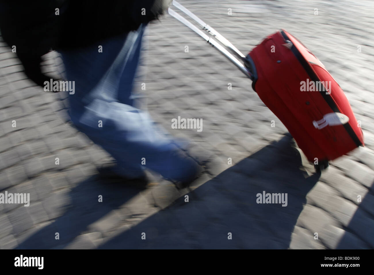 young man pulling trolley luggage case in town Stock Photo - Alamy
