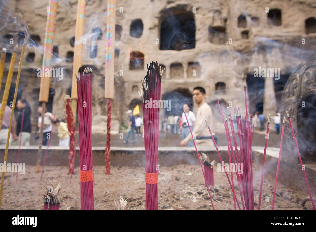 Buddhists light incense at the Yungang Shiku Buddhist Caves complex ...