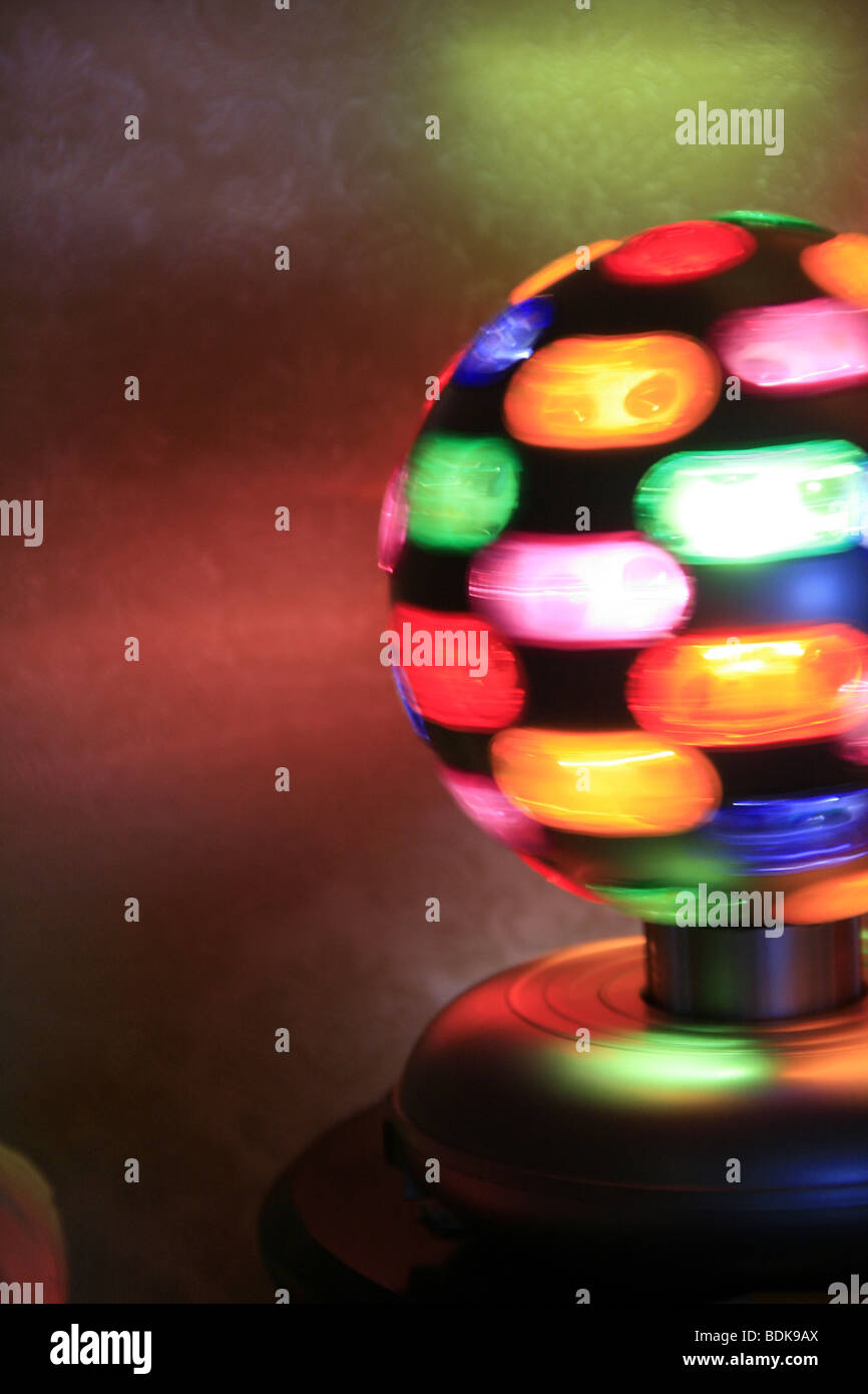 rotating toy ball with colourful lights on table in dark room Stock ...