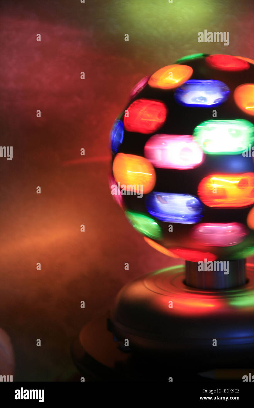 rotating toy ball with colourful lights on table in dark room Stock ...
