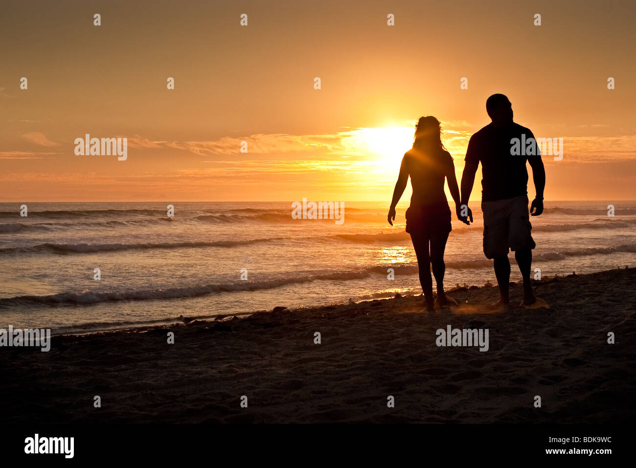 couple walking in sunset Stock Photo - Alamy