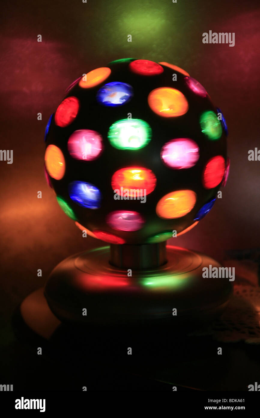 rotating toy ball with colourful lights on table in dark room Stock ...