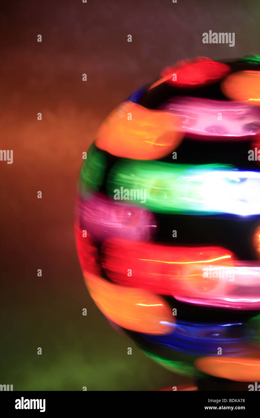rotating toy ball with colourful lights on table in dark room Stock ...