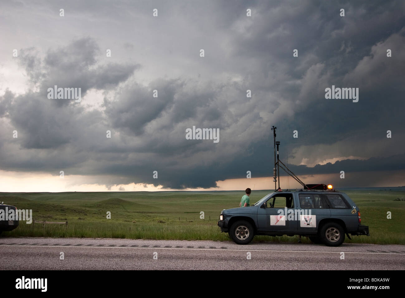 Storm chasers with Project Vortex 2 watch a distant wall cloud and ...