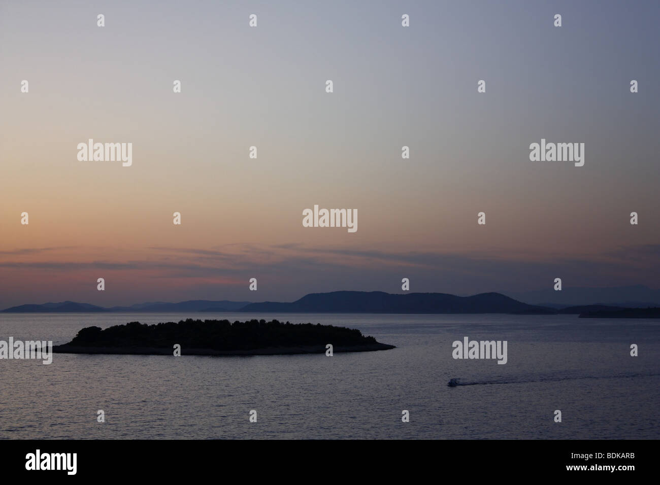 Island in a sunset Stock Photo - Alamy
