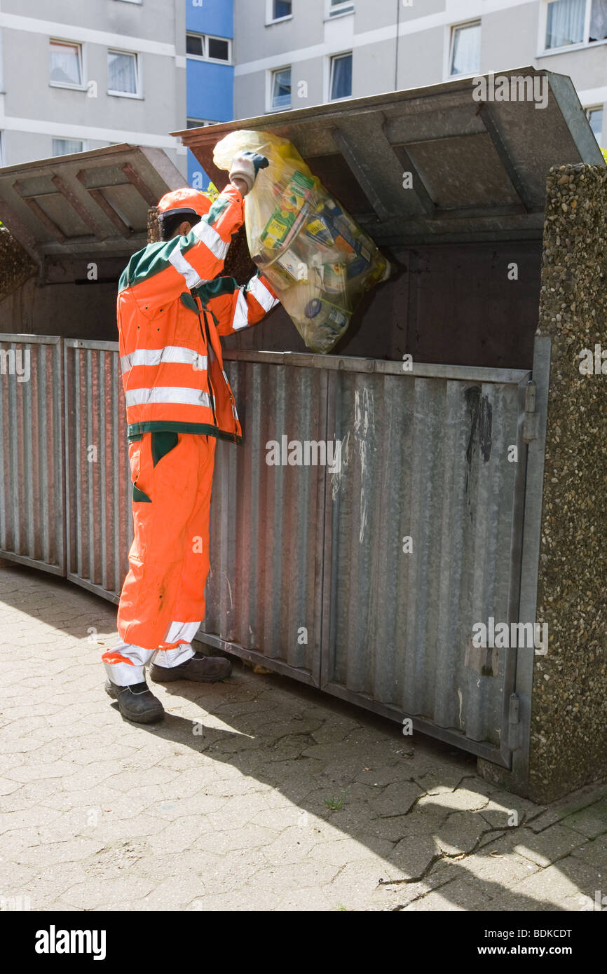 worker throwing waste in a garbage bin Stock Photo - Alamy