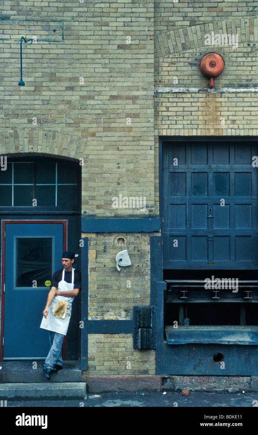 Restaurant kitchen worker on smoke break outside building Stock Photo ...