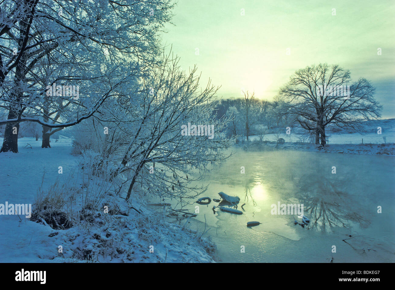 Sunrise on freezing country stream Stock Photo - Alamy
