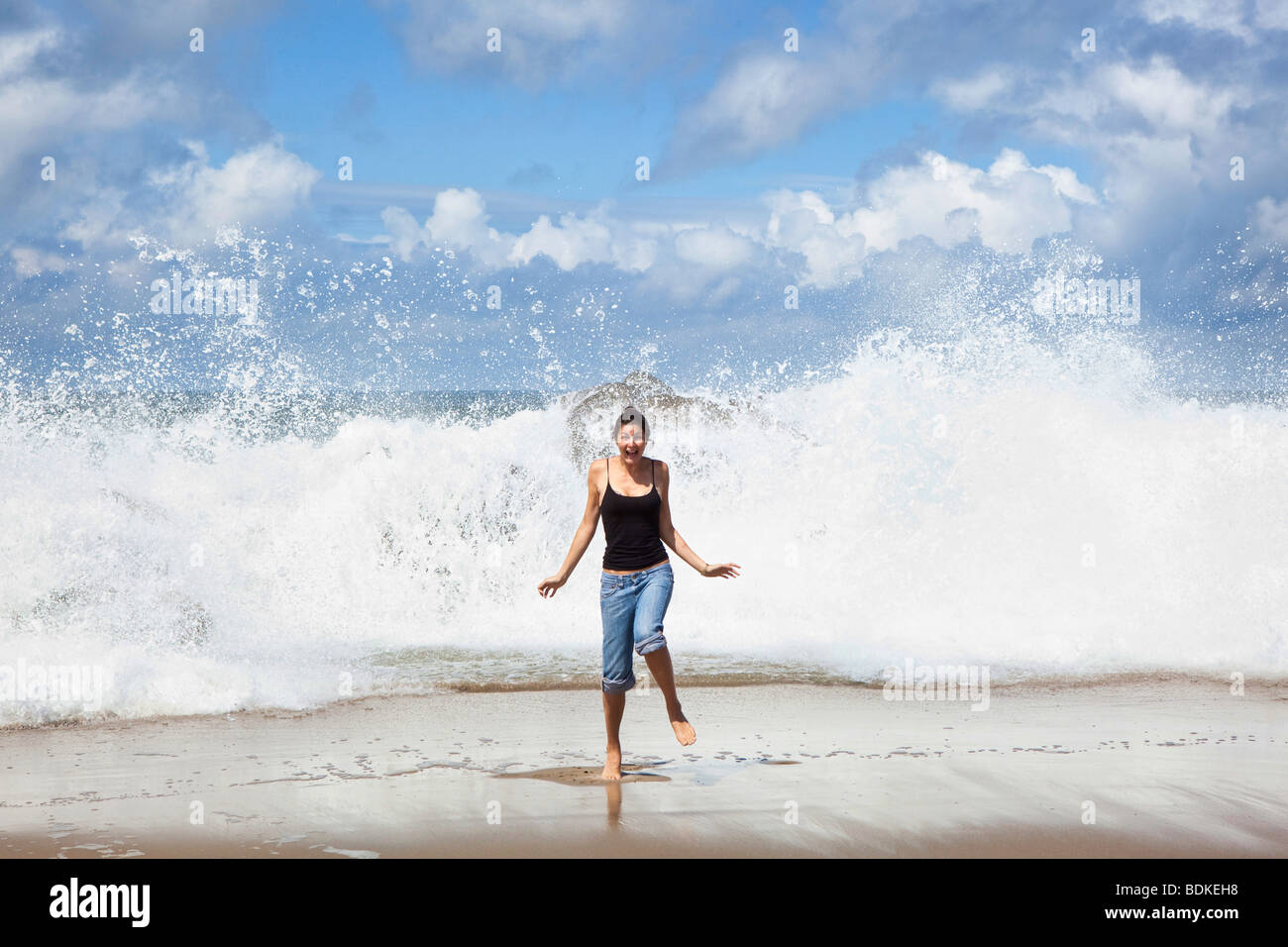 Girl splashed by a wave hi-res stock photography and images - Alamy