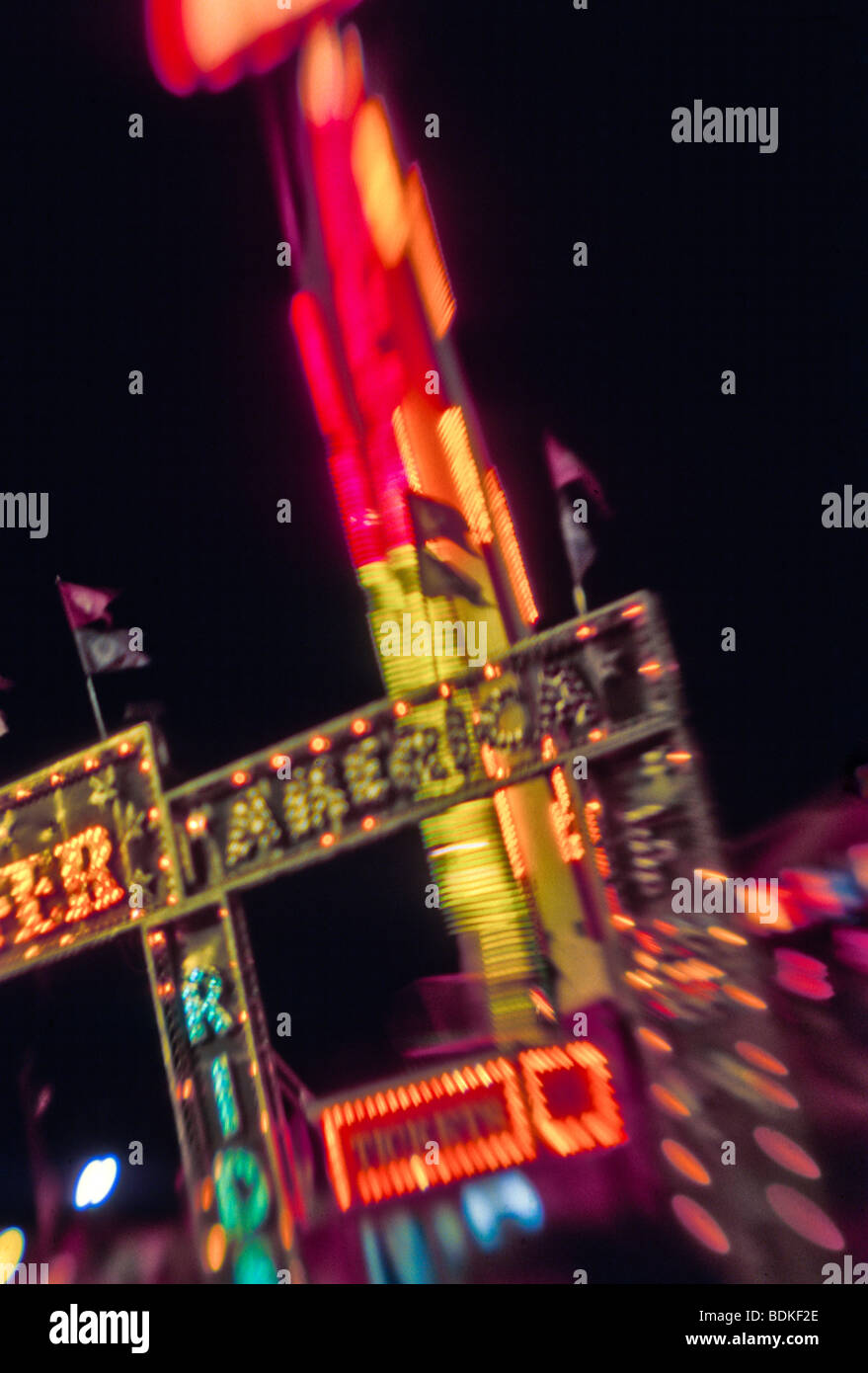 County fair carnival atmosphere along midway rides Stock Photo - Alamy