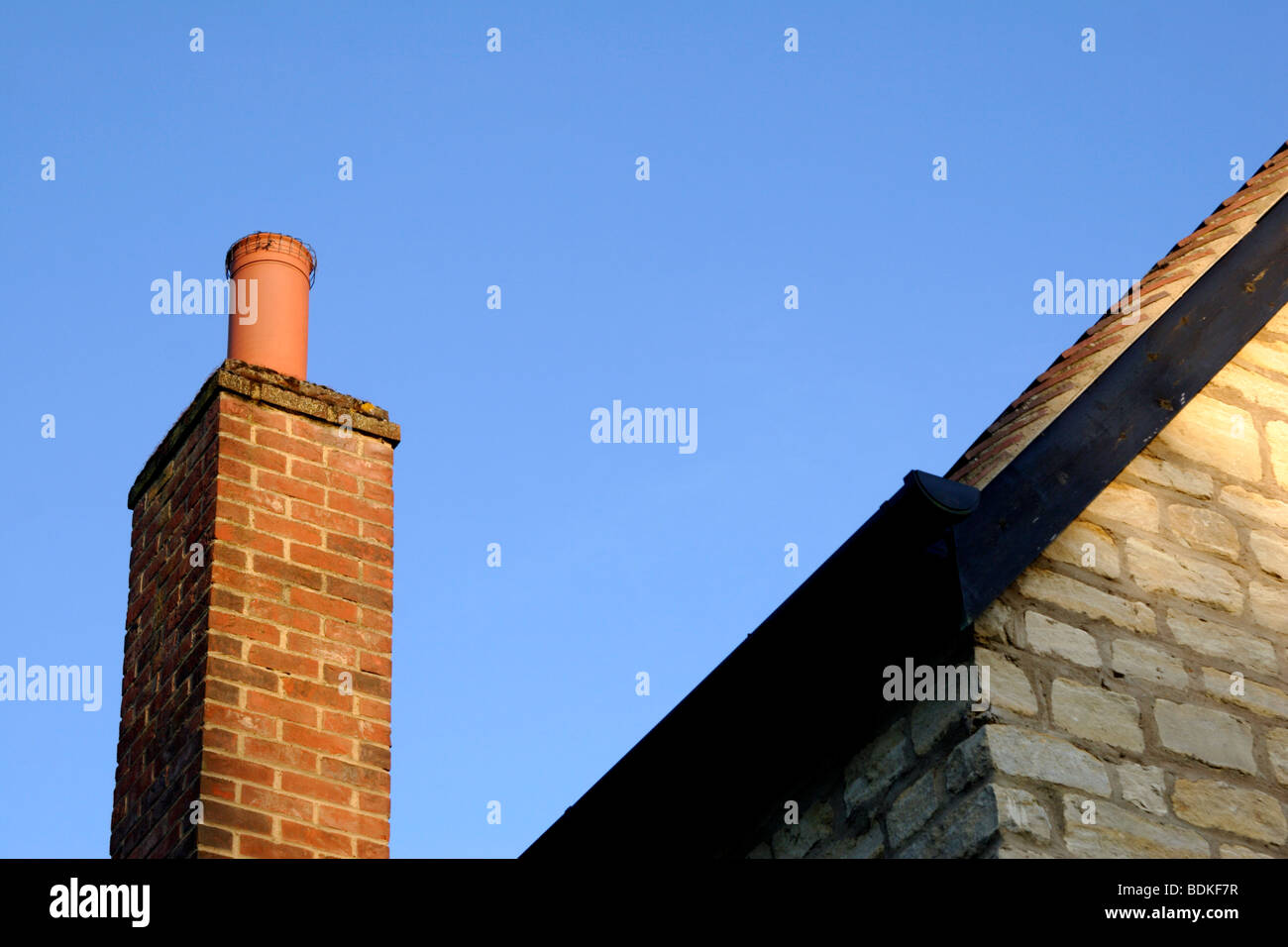 Typical chimney from house against blue sky Stock Photo - Alamy