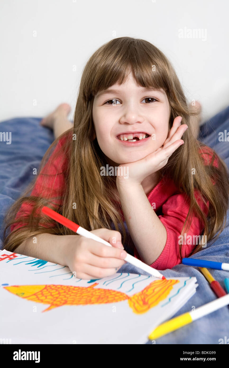 Little girl drawing on paper Stock Photo - Alamy