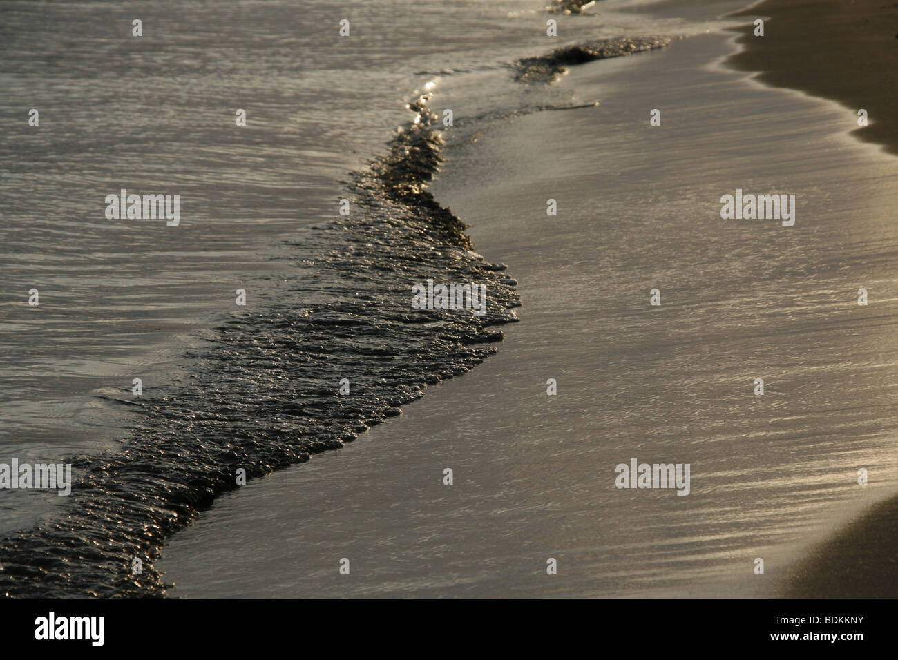 movement of sea waves on sand on beach coast shore Stock Photo - Alamy