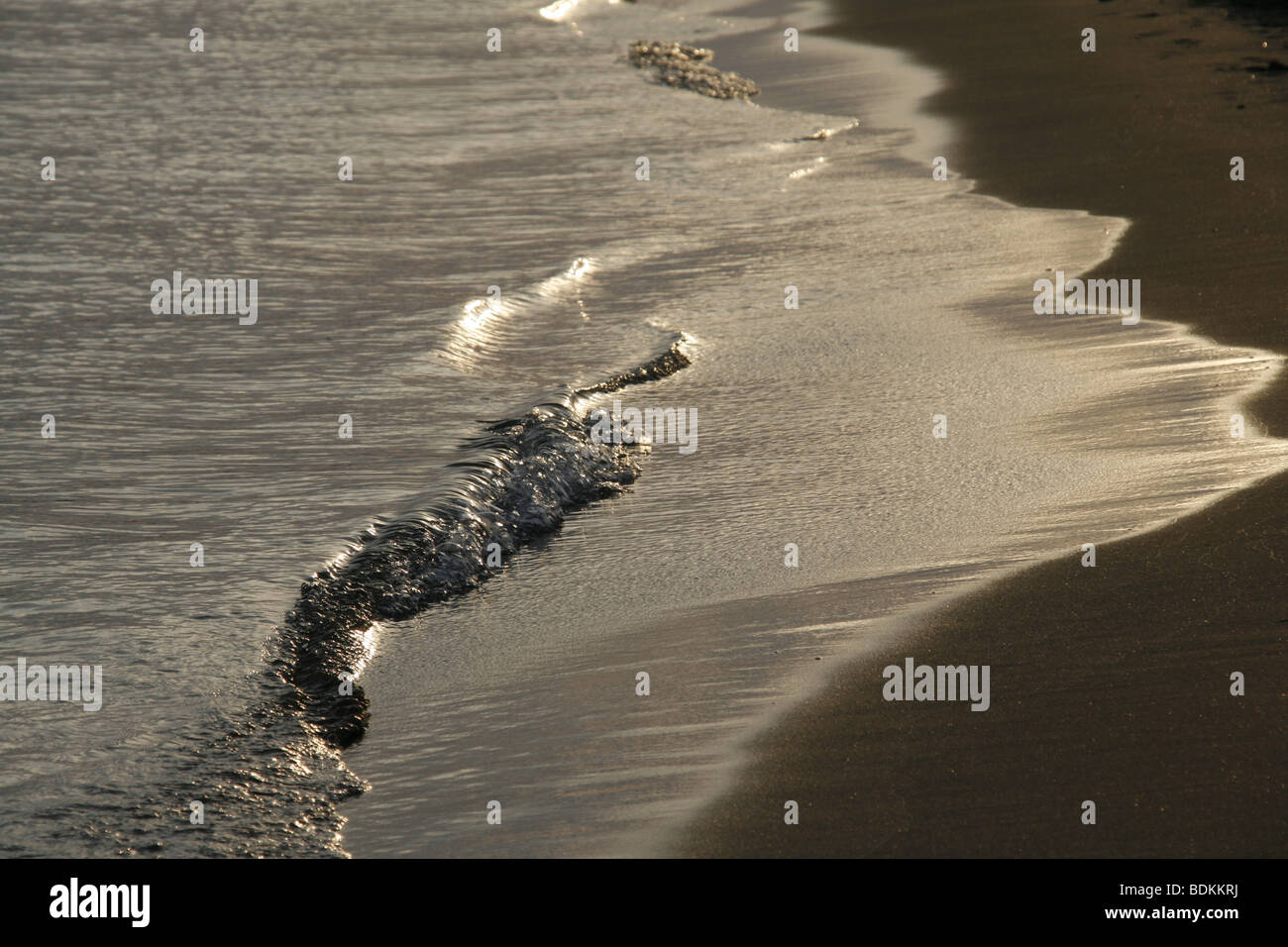 movement of sea waves on sand on beach coast shore Stock Photo - Alamy