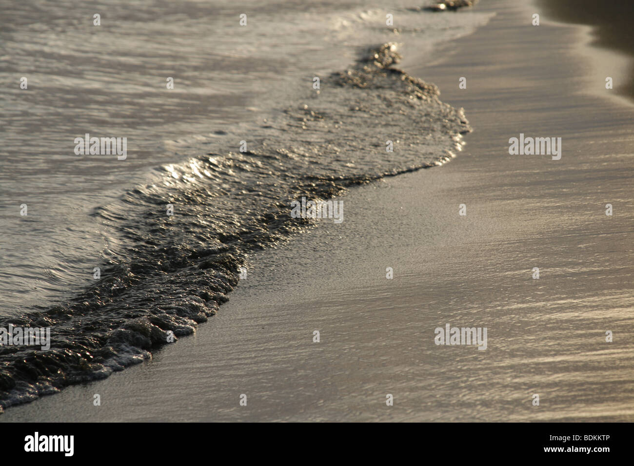 movement of sea waves on sand on beach coast shore Stock Photo - Alamy
