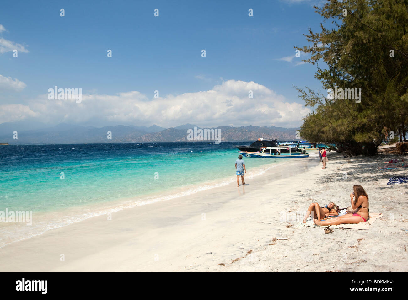 Indonesia, Lombok, Gili Trawangan, beach two sunbathers lying on sand ...