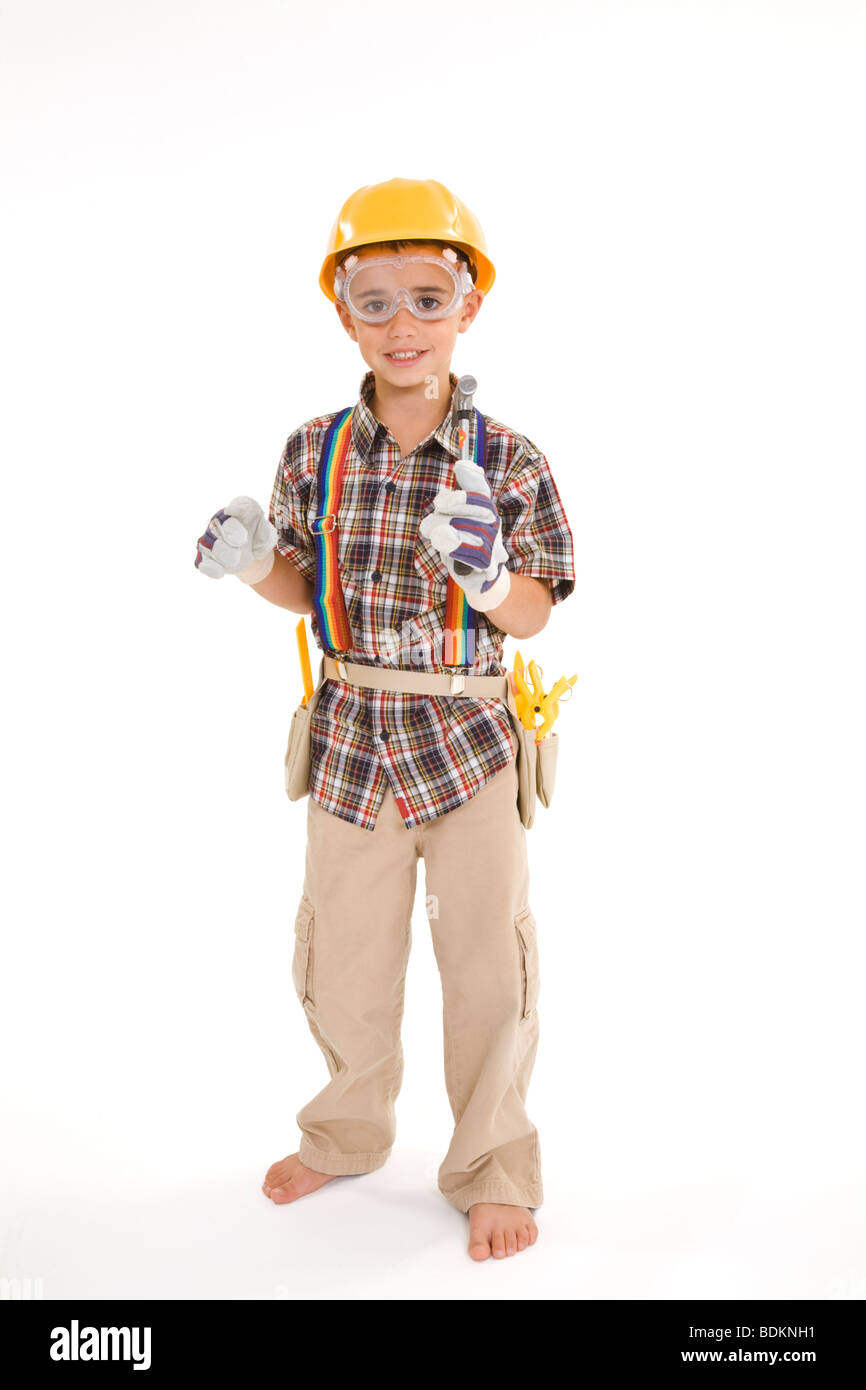 Young caucasian boy dressed in a carpenter outfit standing on a white ...