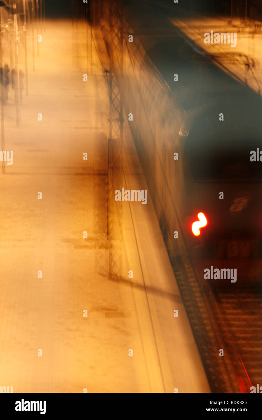 fast train entering station at night Stock Photo - Alamy