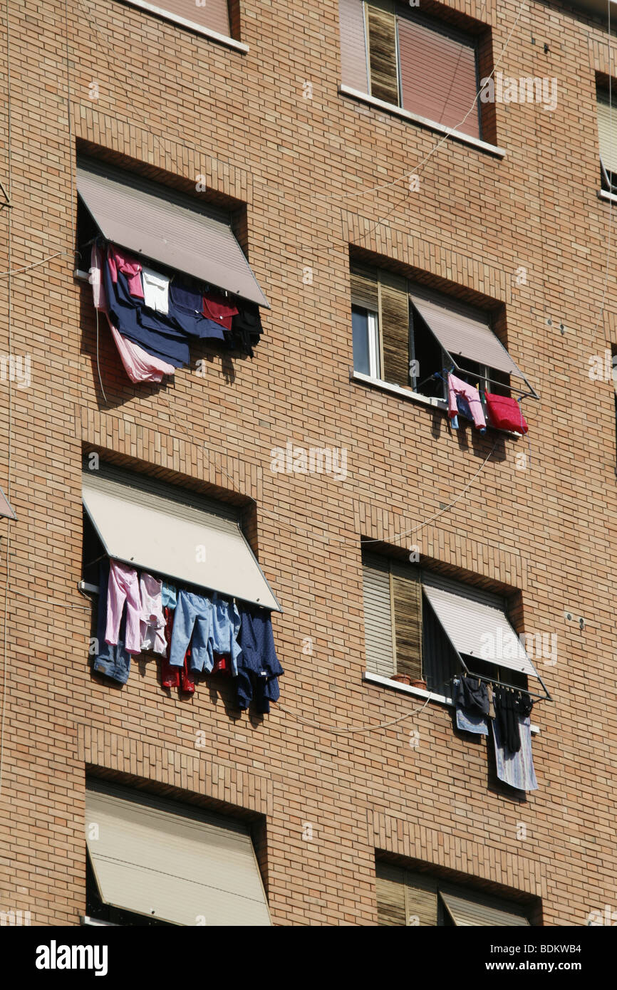 clothes on washing line by window in block of flats in italy Stock ...