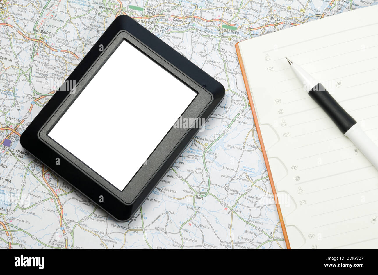GPS global positioning system device arranged with map Stock Photo - Alamy