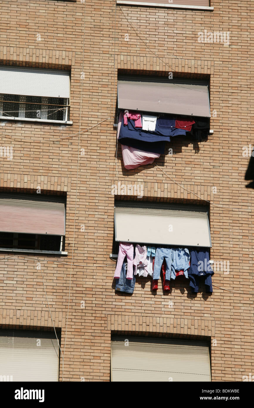 clothes on washing line by window in block of flats in italy Stock ...