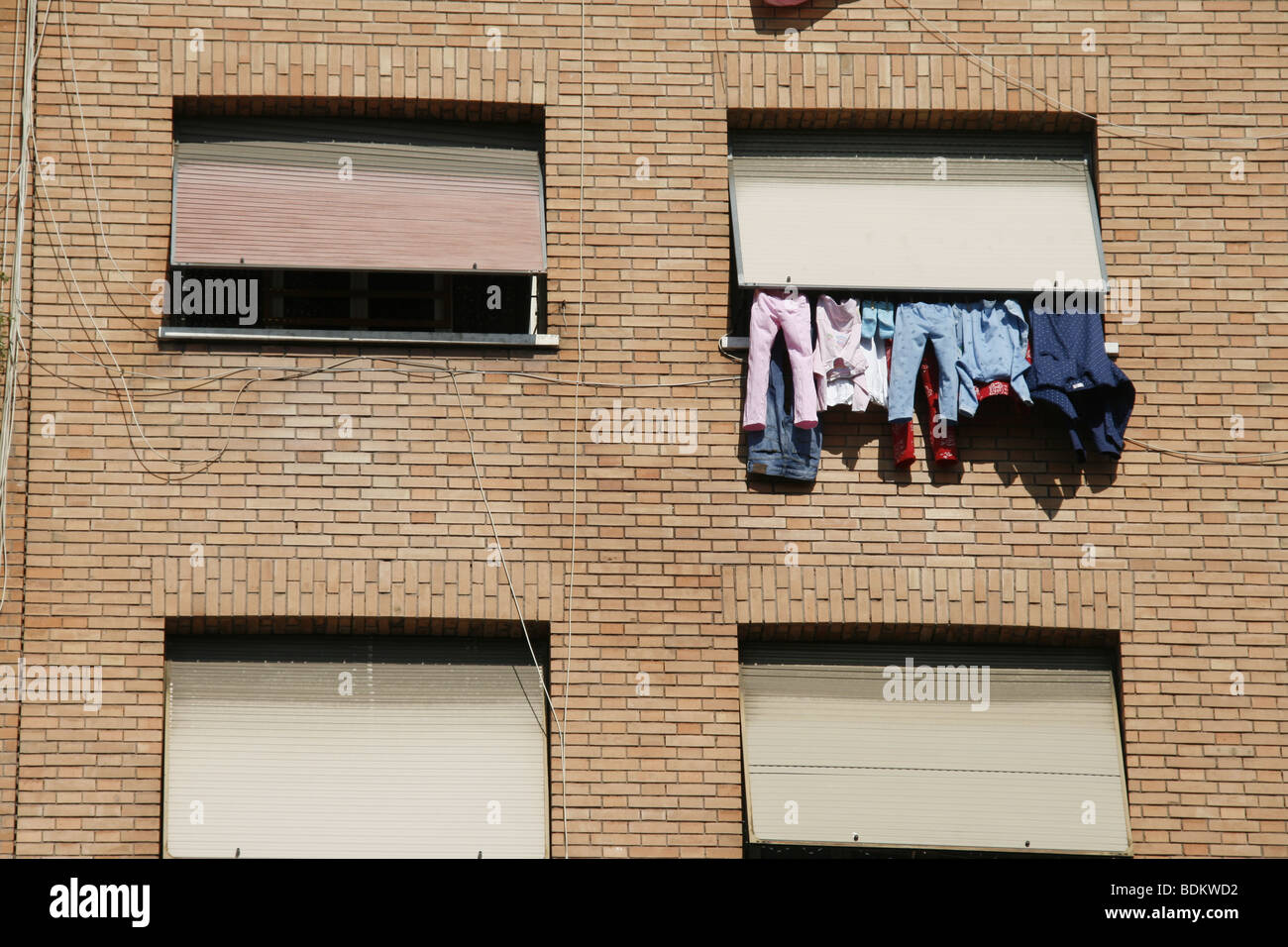 clothes on washing line by window in block of flats in italy Stock ...