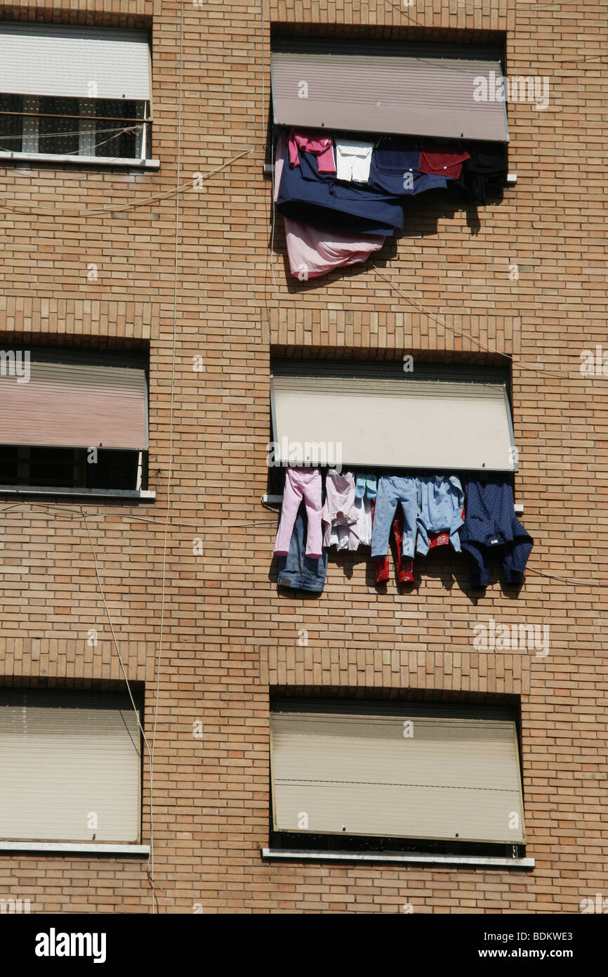 clothes on washing line by window in block of flats in italy Stock ...