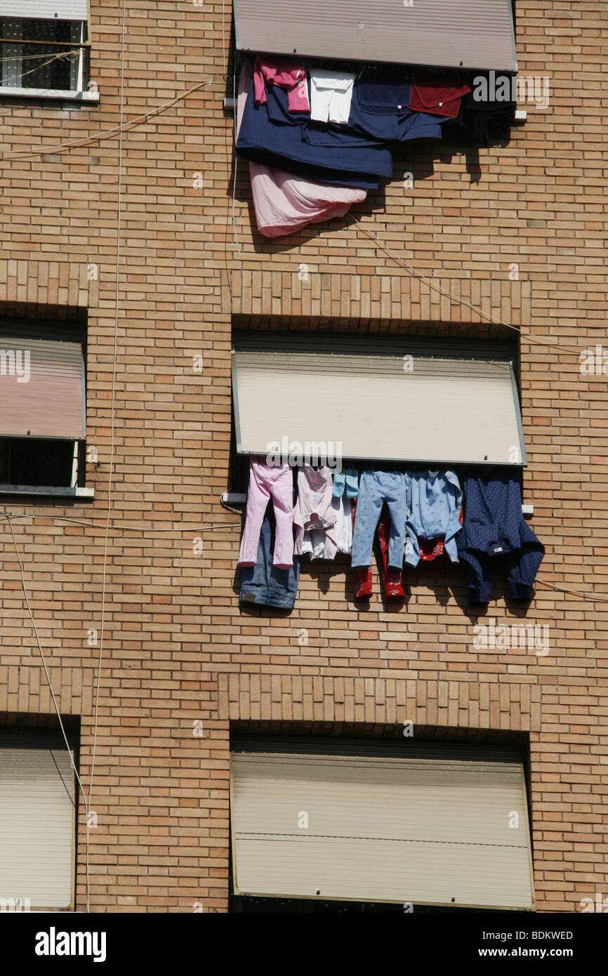 clothes on washing line by window in block of flats in italy Stock ...