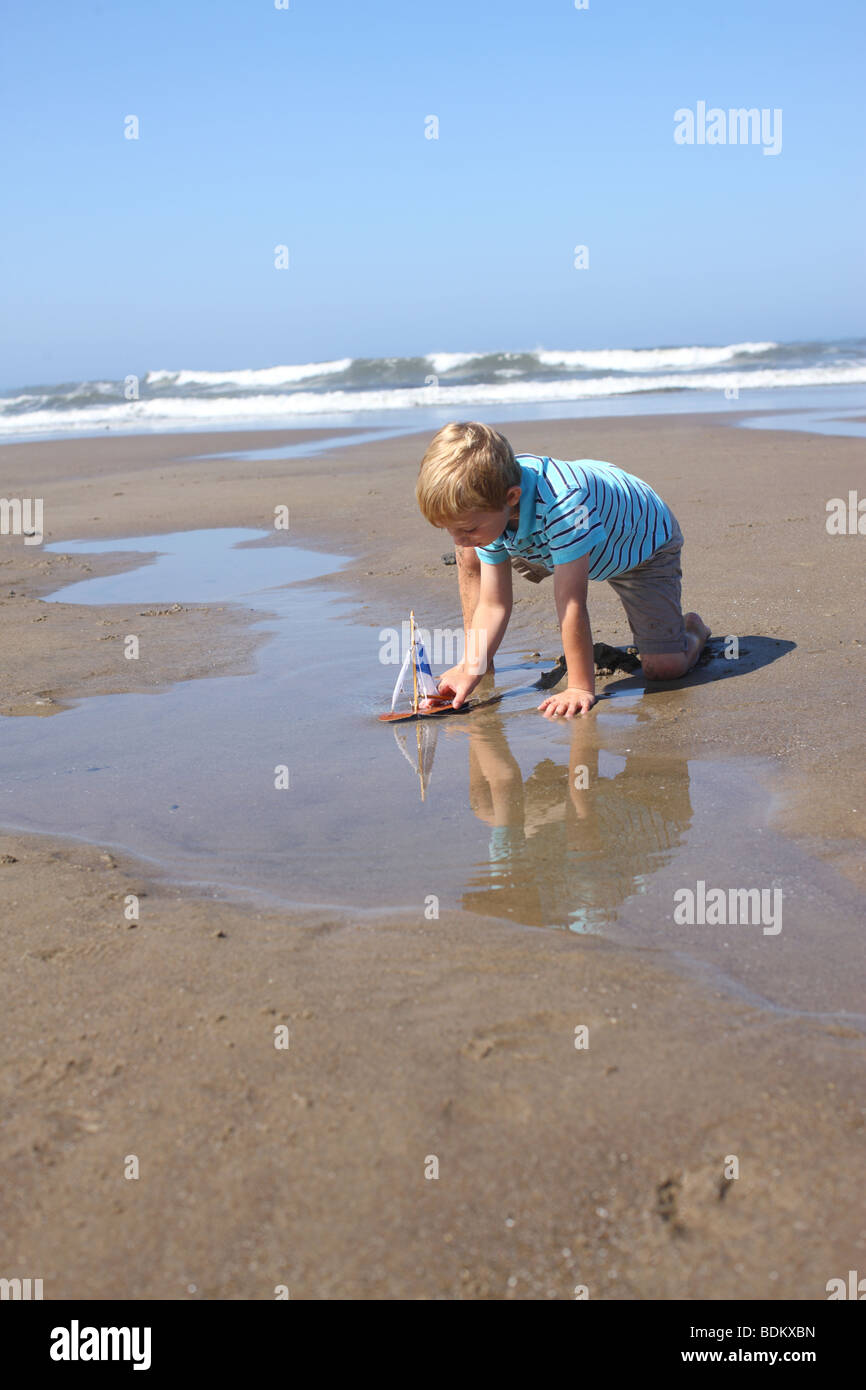 Boy playing toy sailboat hi-res stock photography and images - Alamy