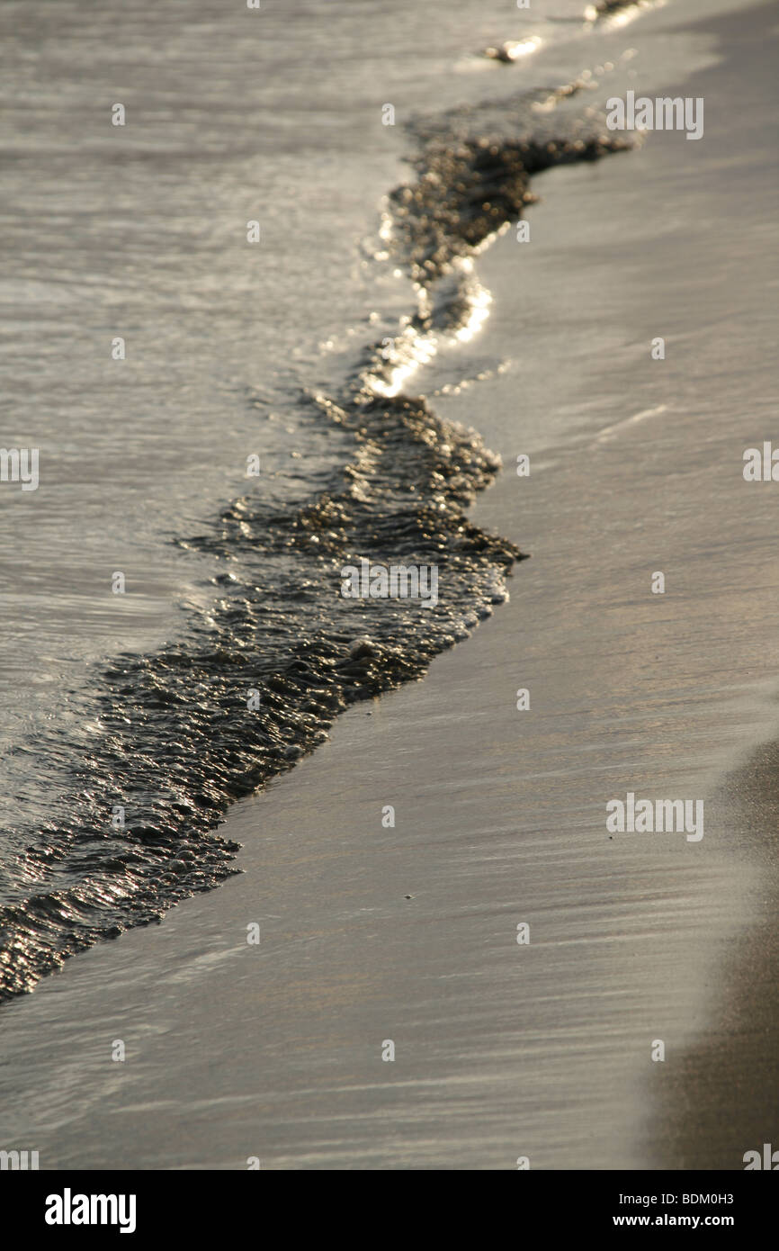 movement of sea waves on sand on beach coast shore Stock Photo - Alamy