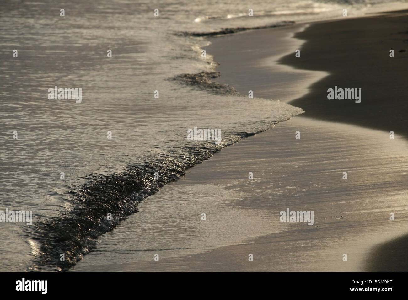 movement of sea waves on sand on beach coast shore Stock Photo - Alamy